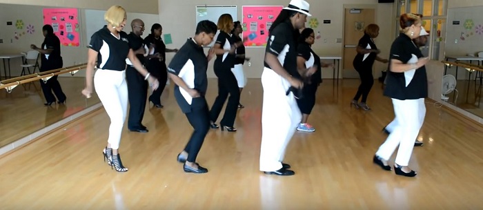 Line dancers glide across the floor in smoothest routine